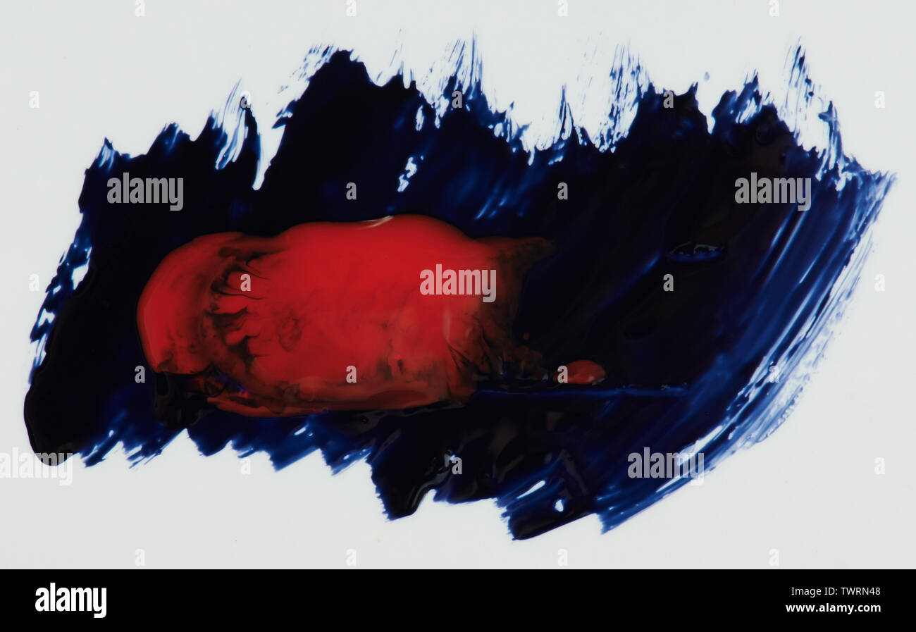 Orange color paint spot on dark blue background Stock Photo - Alamy