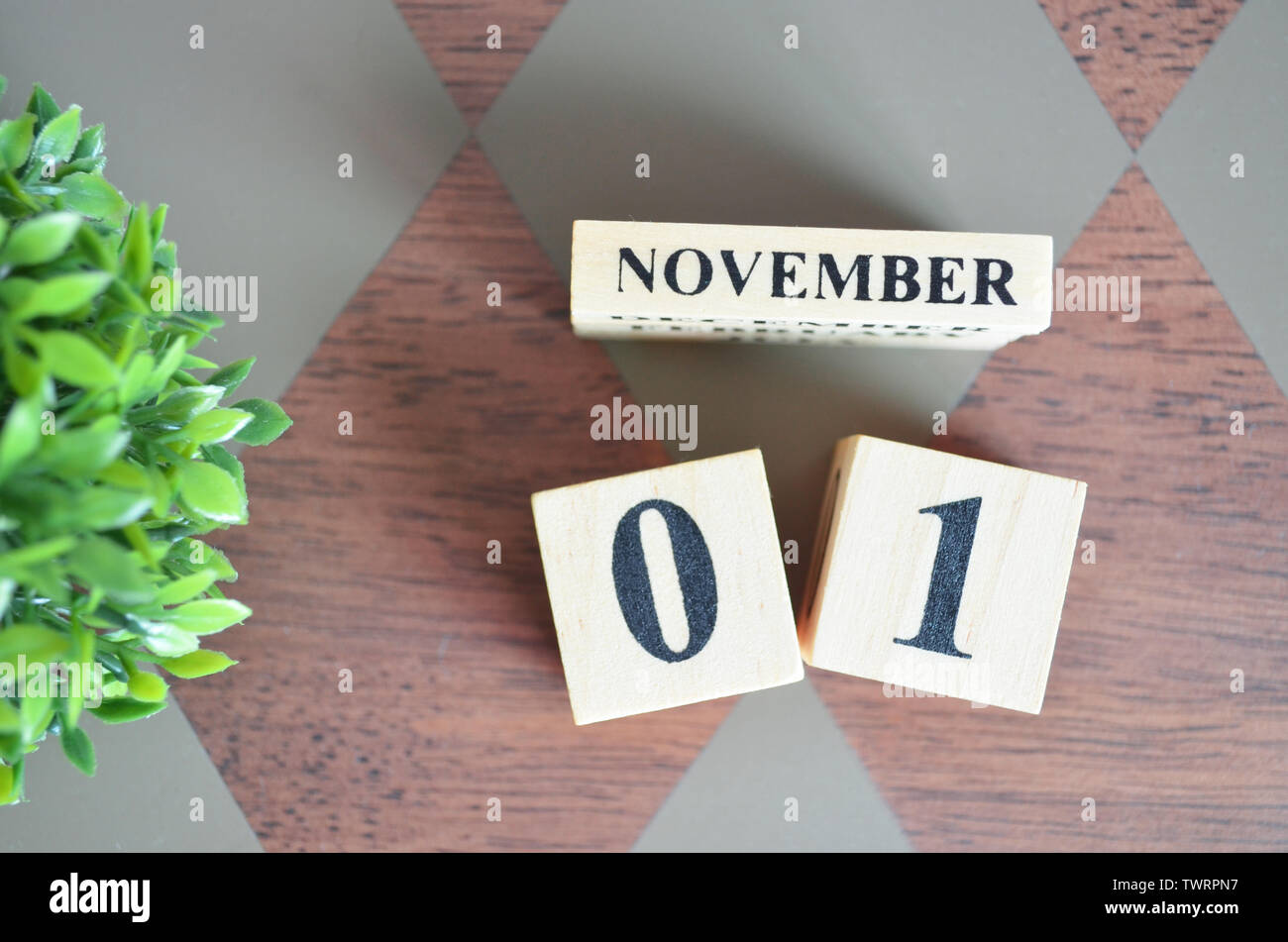 Date of November with leaf on diamond pattern table for background ...