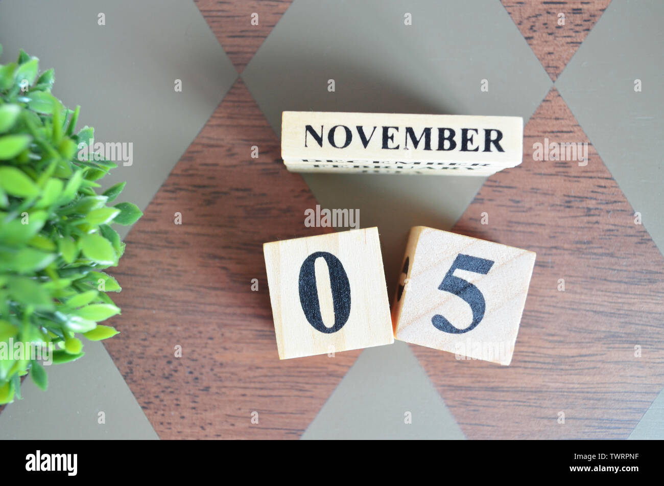 Date of November with leaf on diamond pattern table for background ...