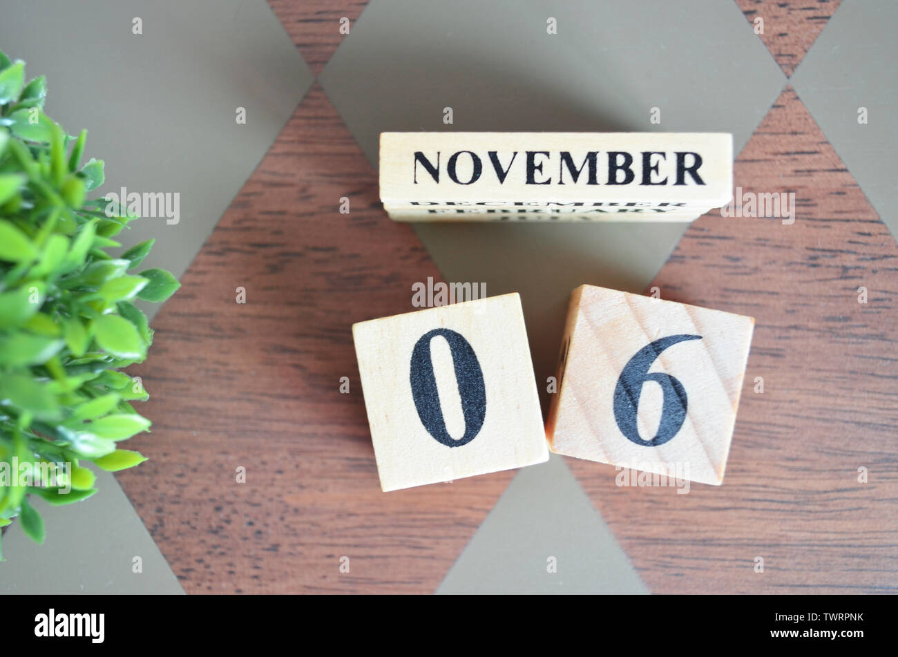 Date of November with leaf on diamond pattern table for background ...