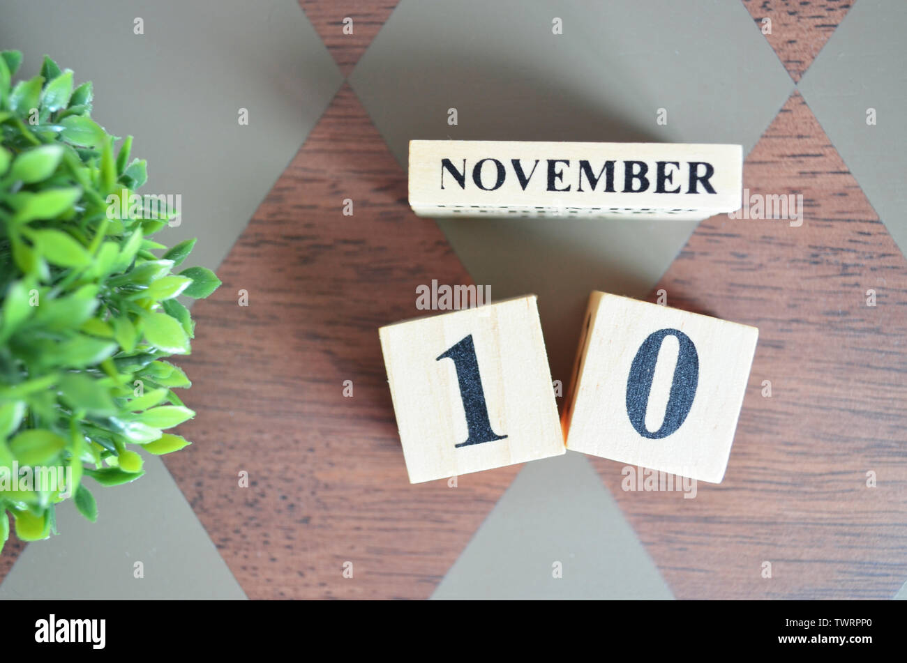 Date of November with leaf on diamond pattern table for background ...