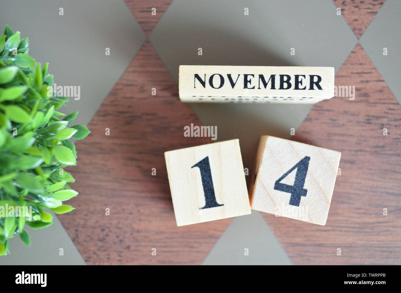 Date of November with leaf on diamond pattern table for background ...
