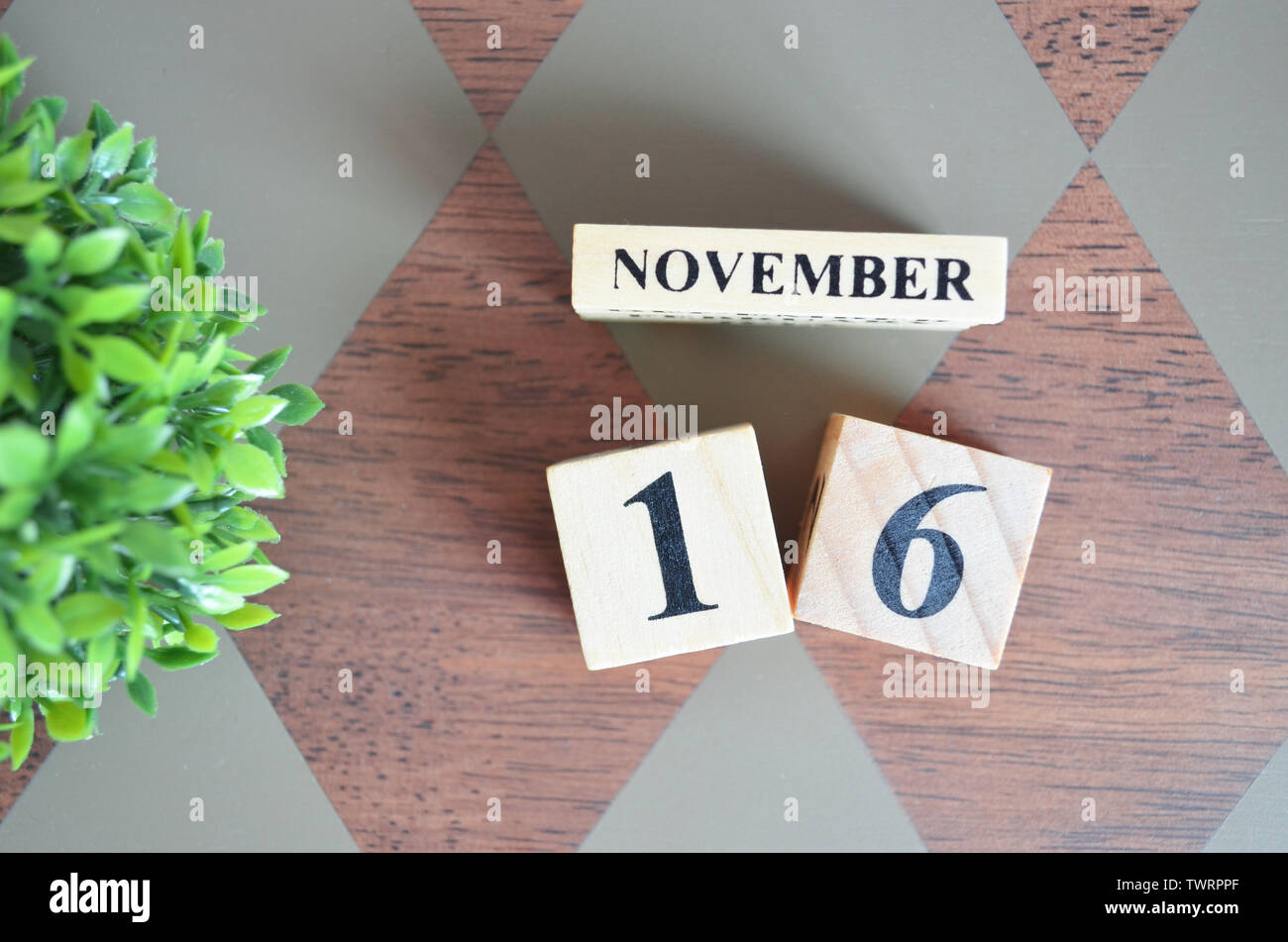 Date of November with leaf on diamond pattern table for background ...