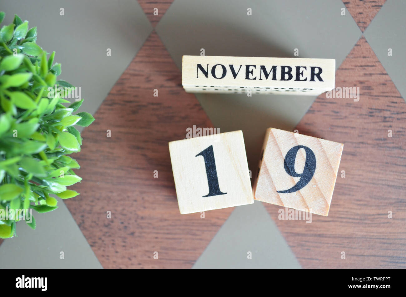 Date of November with leaf on diamond pattern table for background ...