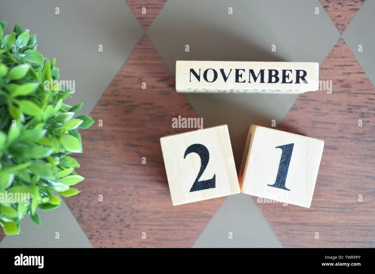 Date of November with leaf on diamond pattern table for background ...