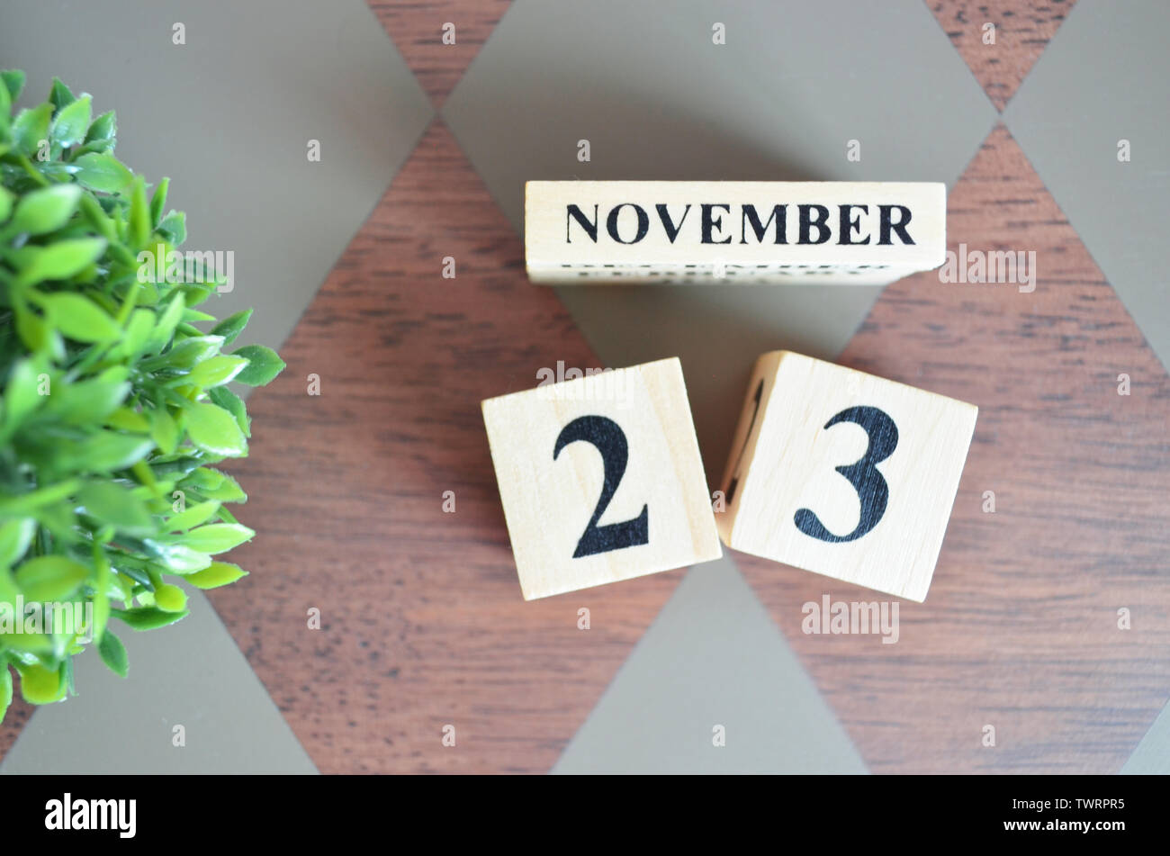 Date of November with leaf on diamond pattern table for background ...