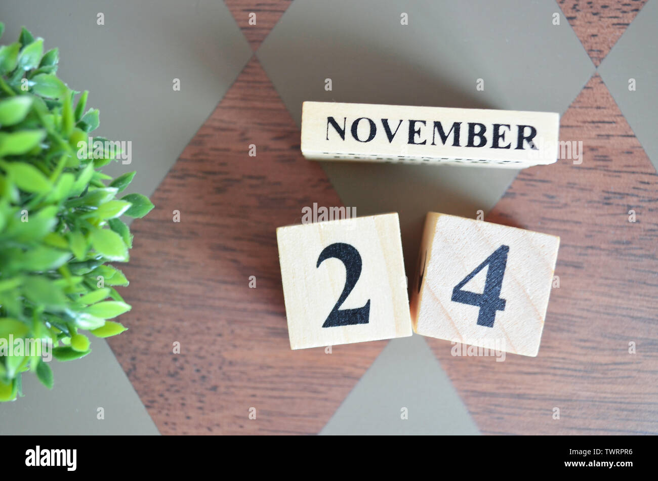 Date of November with leaf on diamond pattern table for background ...