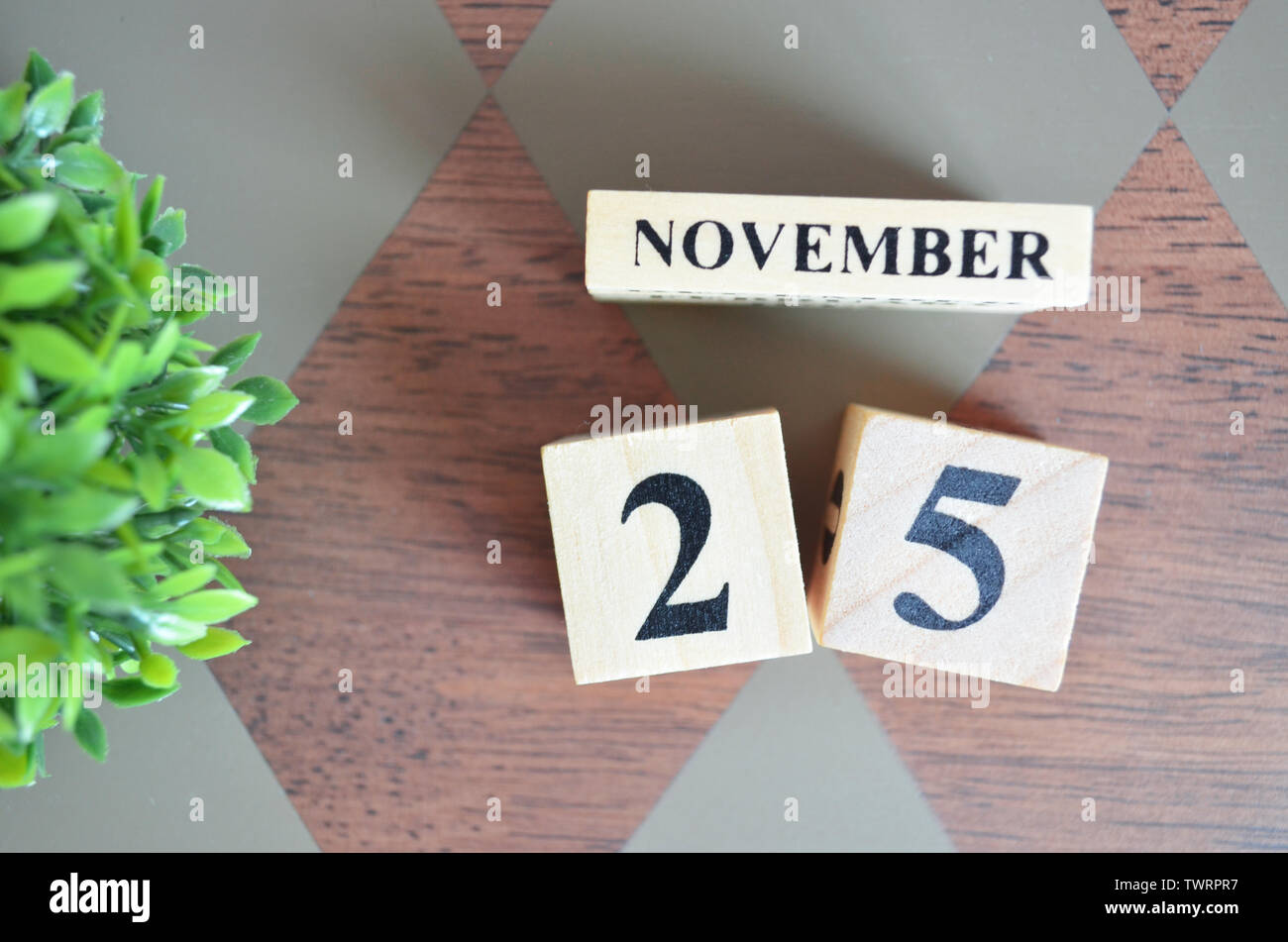 Date of November with leaf on diamond pattern table for background ...