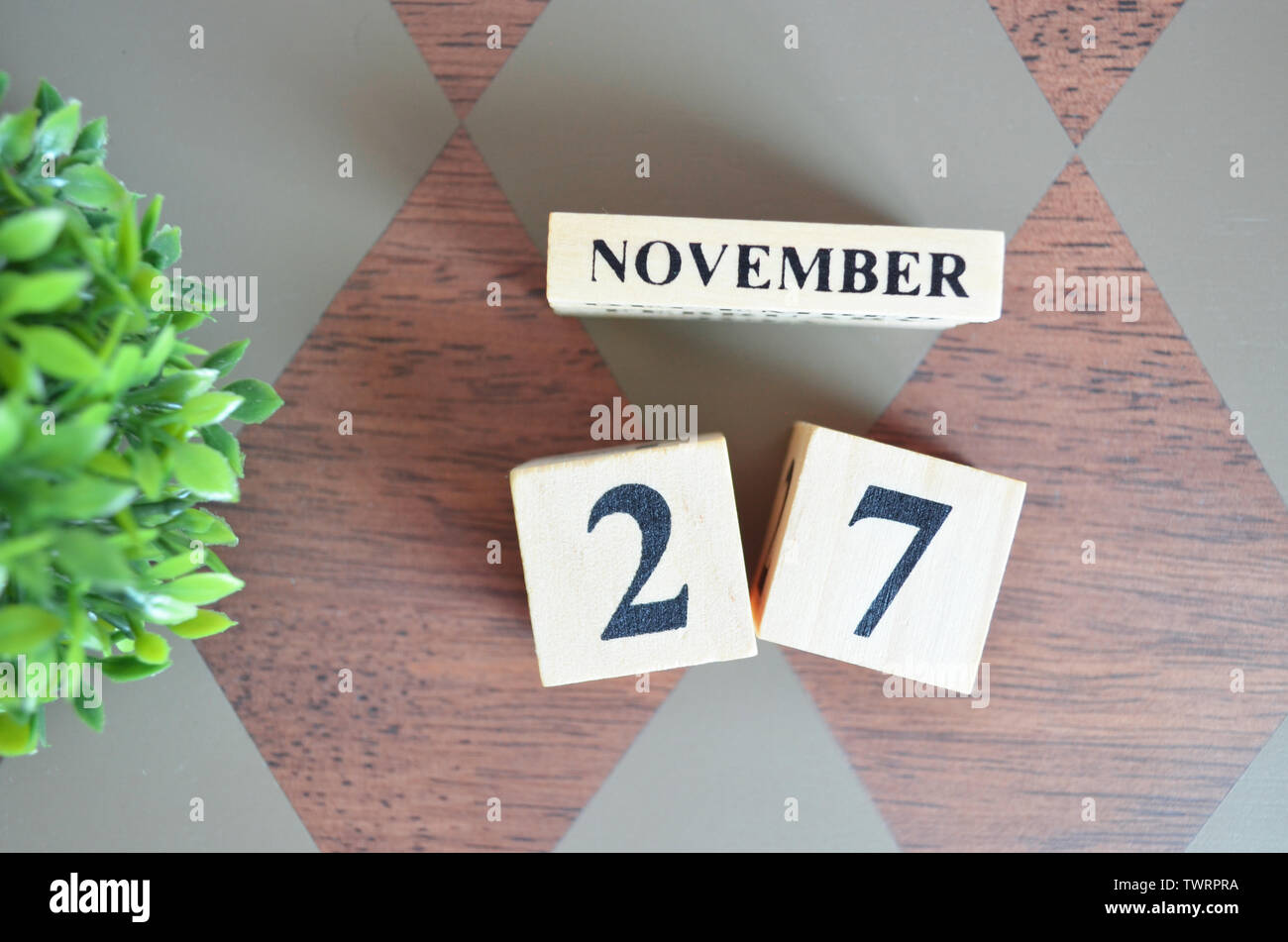 Date of November with leaf on diamond pattern table for background ...