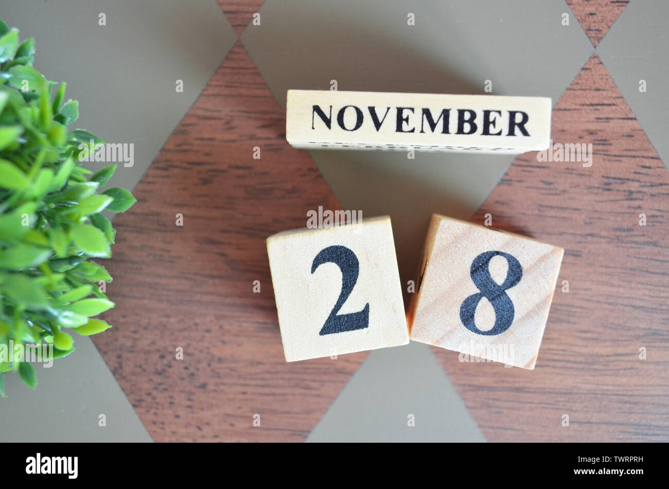 Date of November with leaf on diamond pattern table for background ...