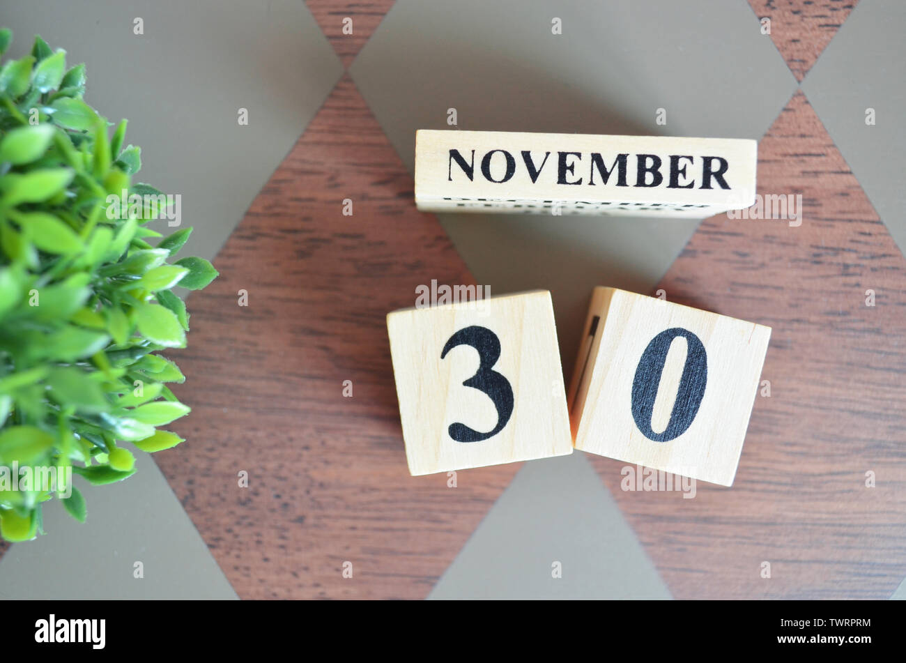 Date of November with leaf on diamond pattern table for background ...