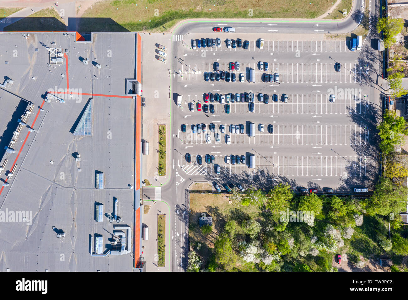 aerial view of city shopping mall with rows of cars at parking area ...