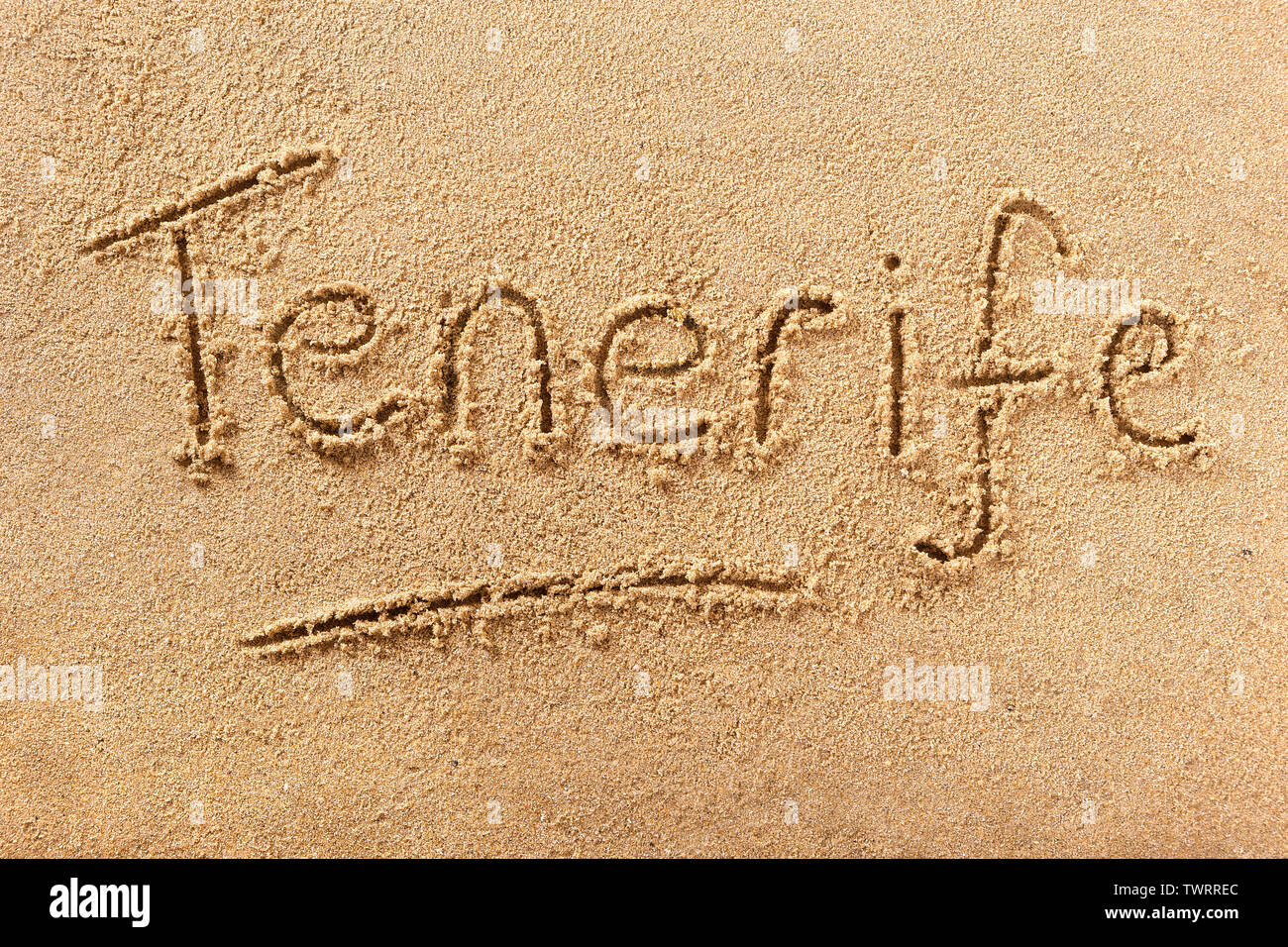 Tenerife beach word written in sand Stock Photo - Alamy