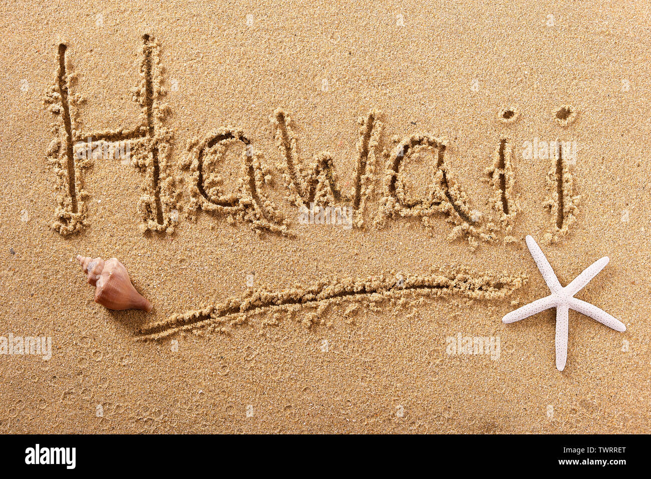 Hawaii beach word message written in sand Stock Photo - Alamy