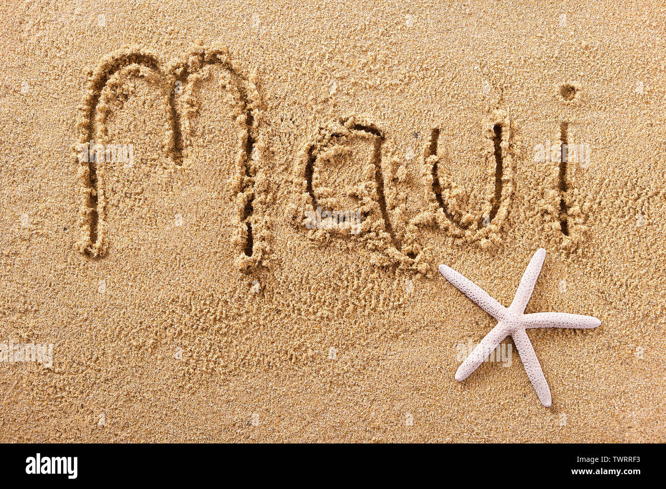 Maui hawaii beach word written in sand Stock Photo - Alamy