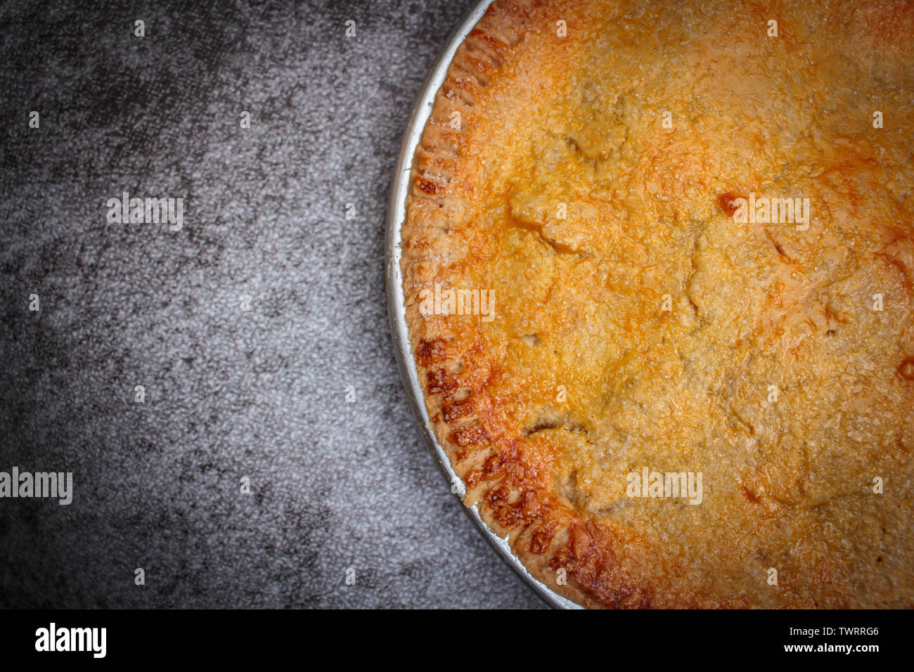 Homemade rustic apple pie on rock black background Stock Photo - Alamy