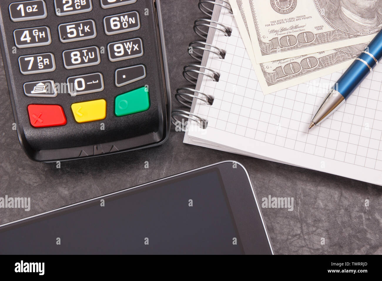Payment terminal, smartphone with NFC technology, notepad for writing ...