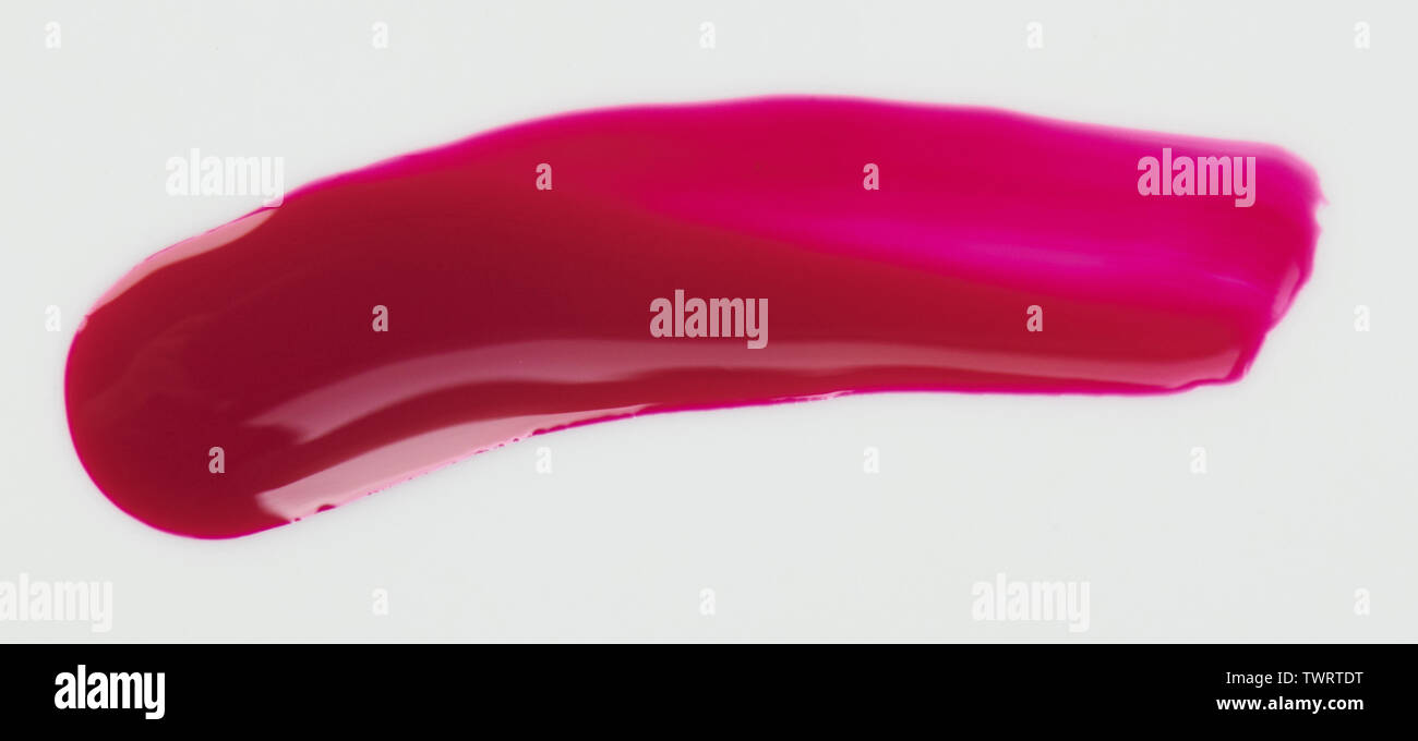 Glossy deep red paint stroke isolated on white background close up view ...