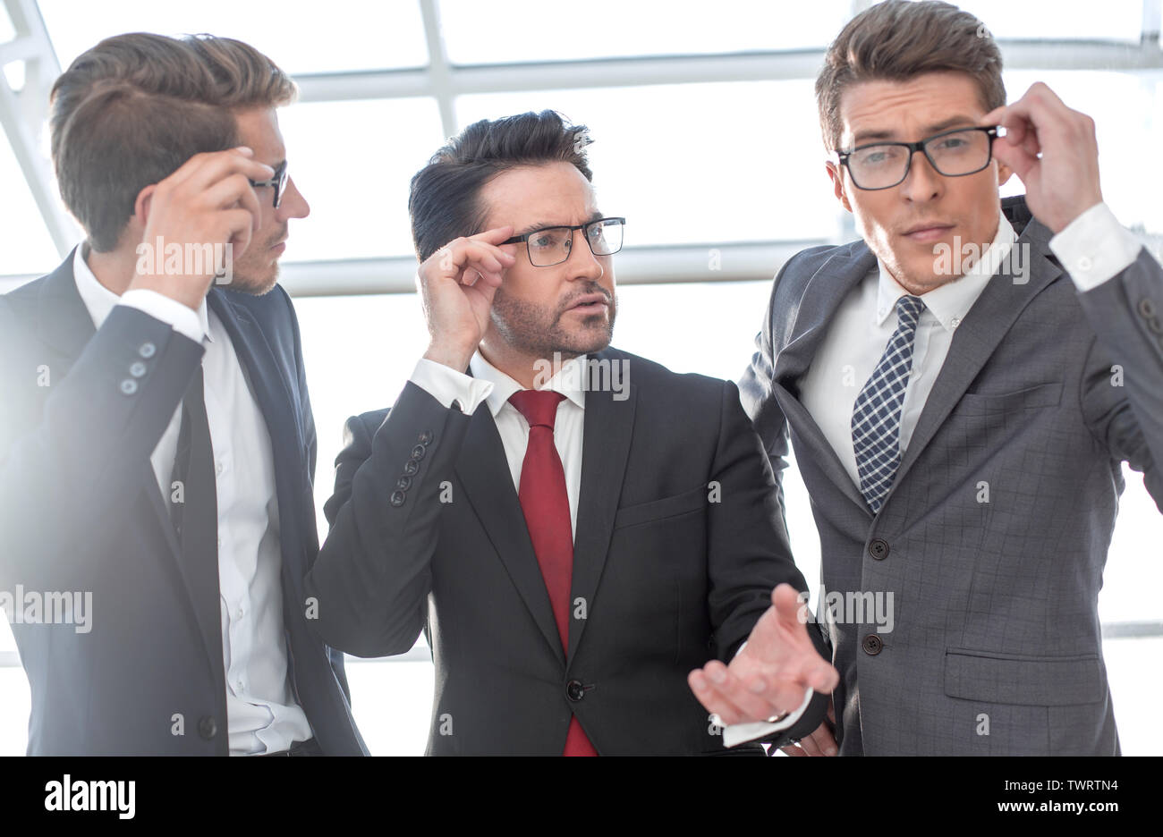 close up.a group of confused businessmen Stock Photo - Alamy