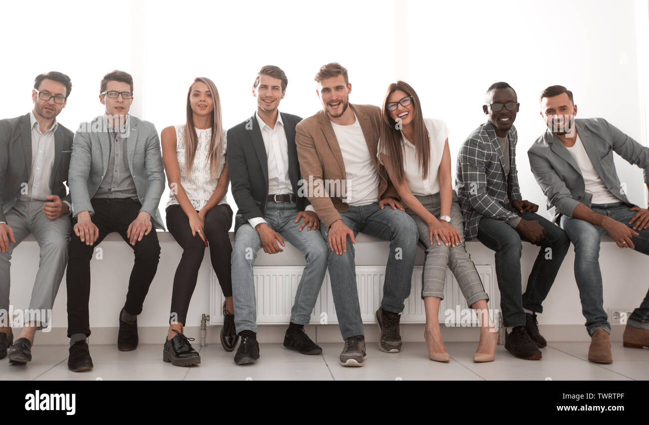 young people are waiting for an interview, sitting in the office lobby ...