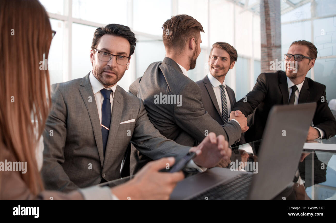 Serious business people looking at computer Stock Photo - Alamy