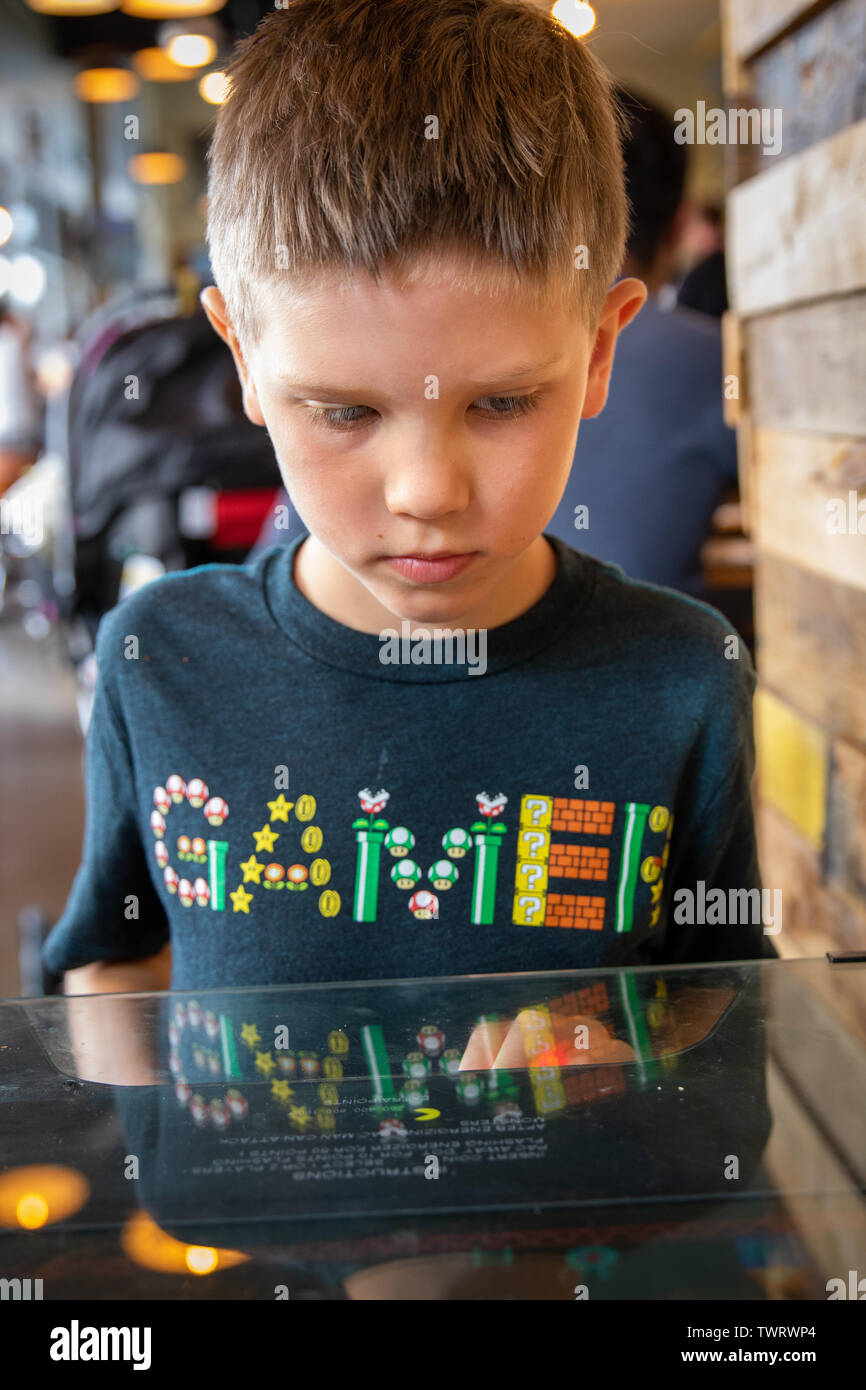Boy playing video game Stock Photo - Alamy