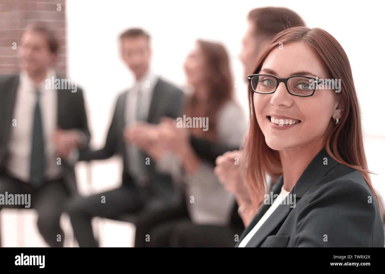 Attractive office worker standing Stock Photo - Alamy