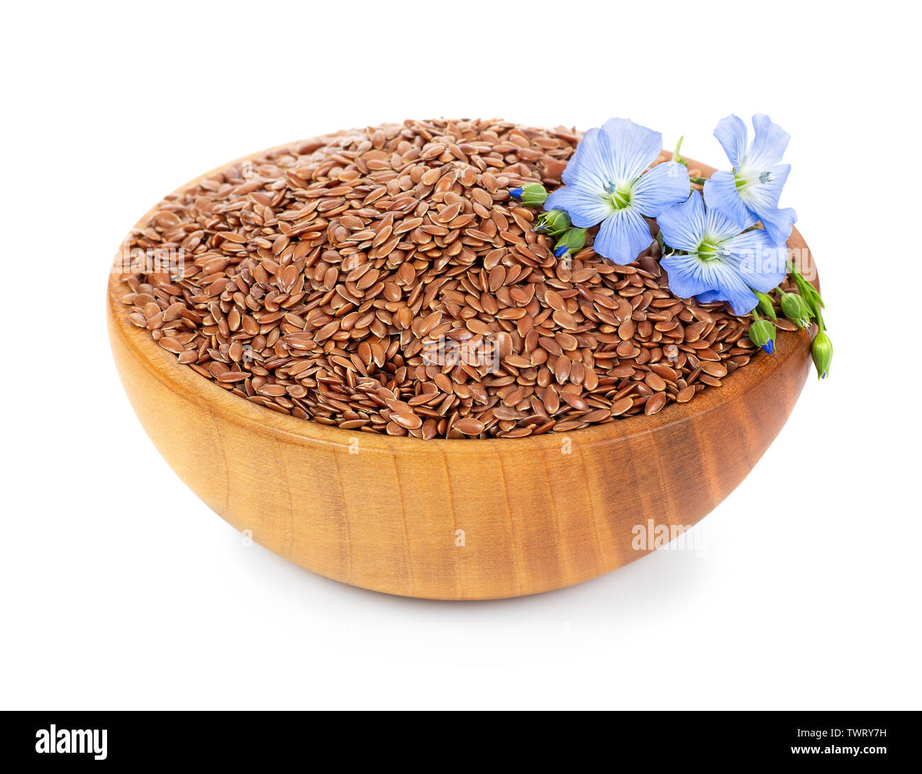 flax seeds and blue flowers in wooden bowl isolated on white background ...