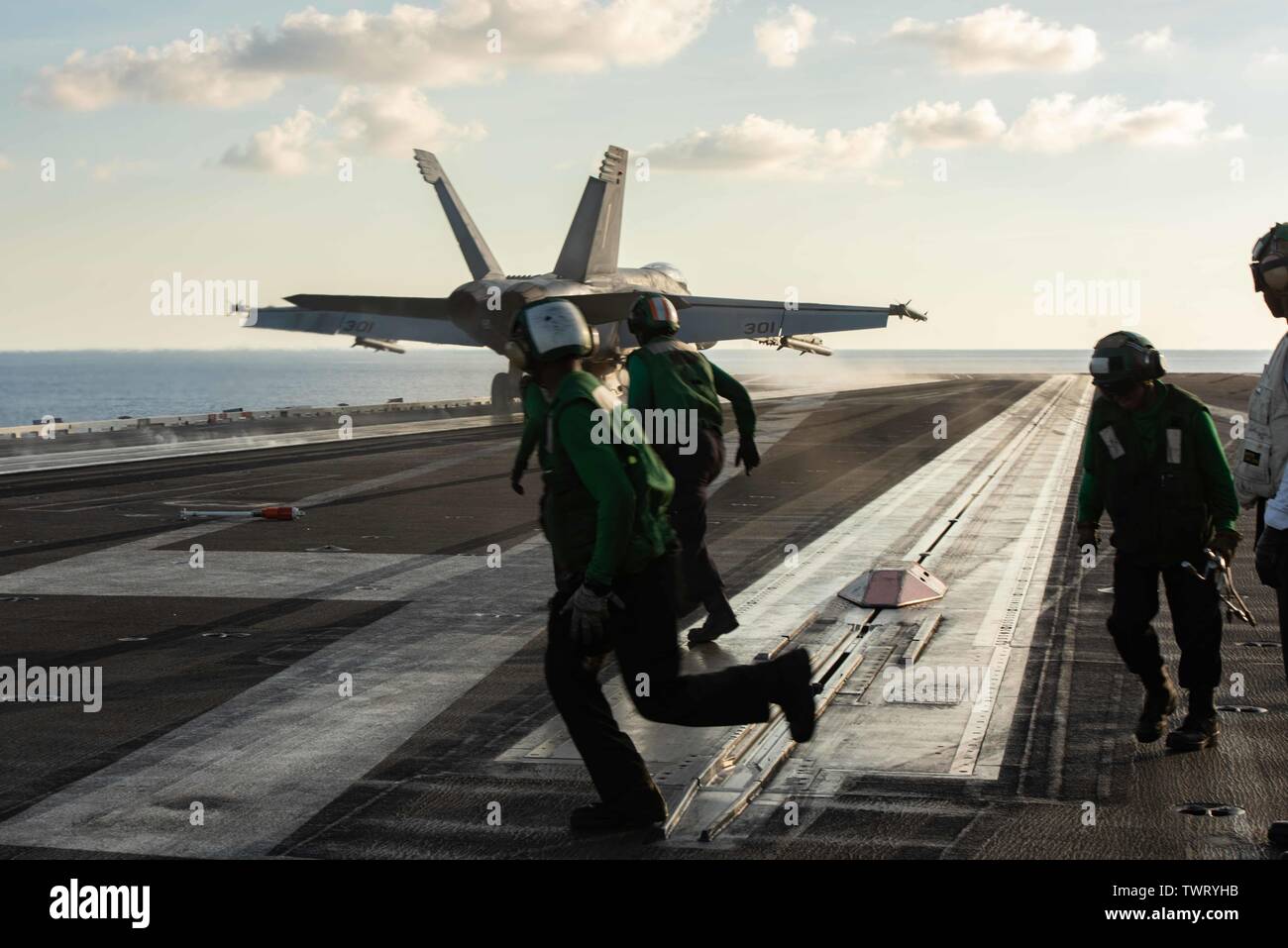 190620-N-CL027-2299 SOUTH CHINA SEA (June 20, 2019) Sailors run to ...
