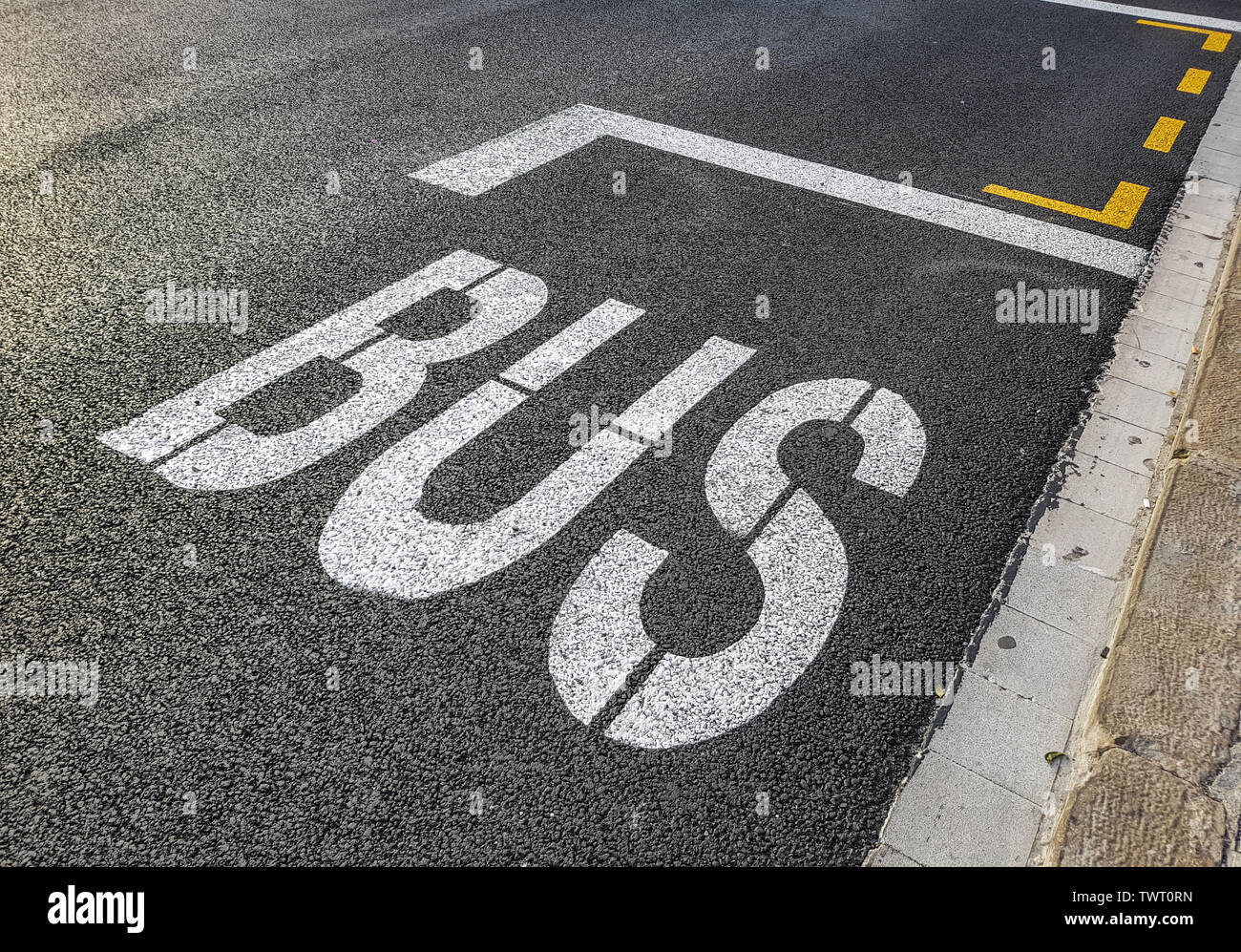 Lettering with white paint the BUS on the pavement Stock Photo - Alamy