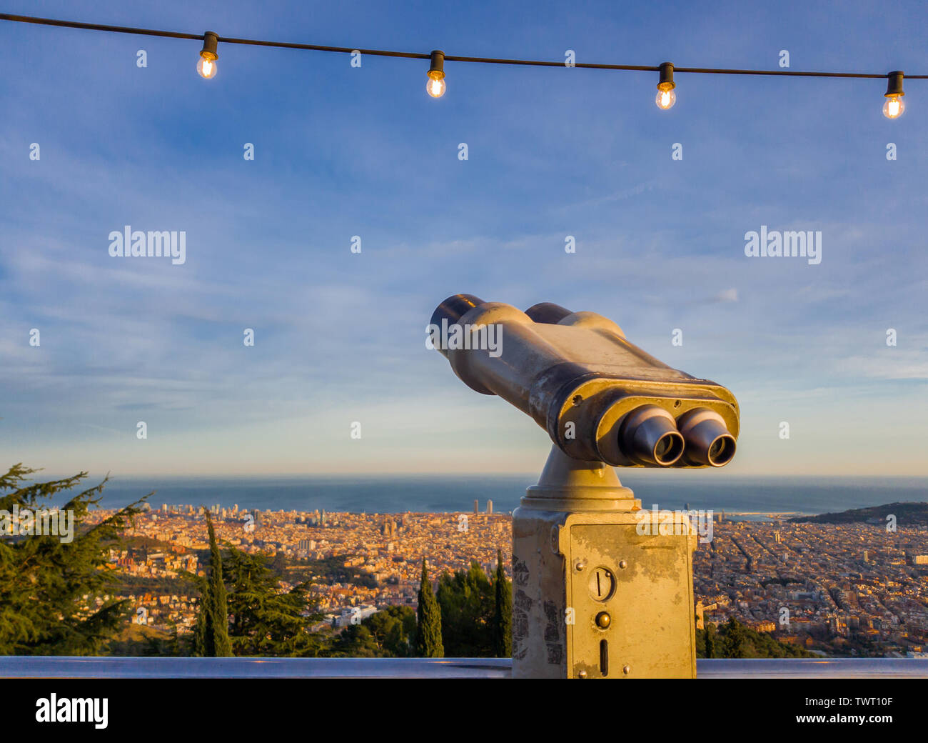Magnifying binoculars for sightseeing. Evening landscape of Barcelona ...