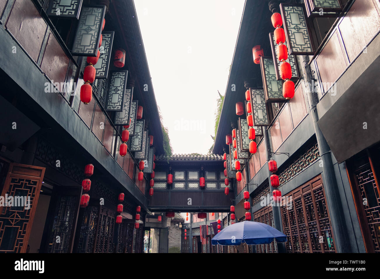 Ancient chinese alley with red lanterns and wooden windows in ...