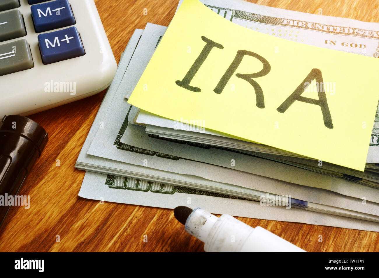 IRA individual retirement account. Stack of money and calculator Stock ...