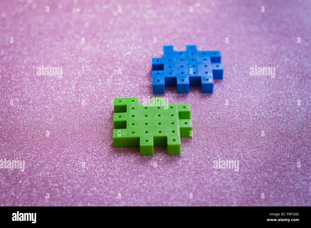 Colorful plastic puzzle pieces on pink Background Stock Photo - Alamy