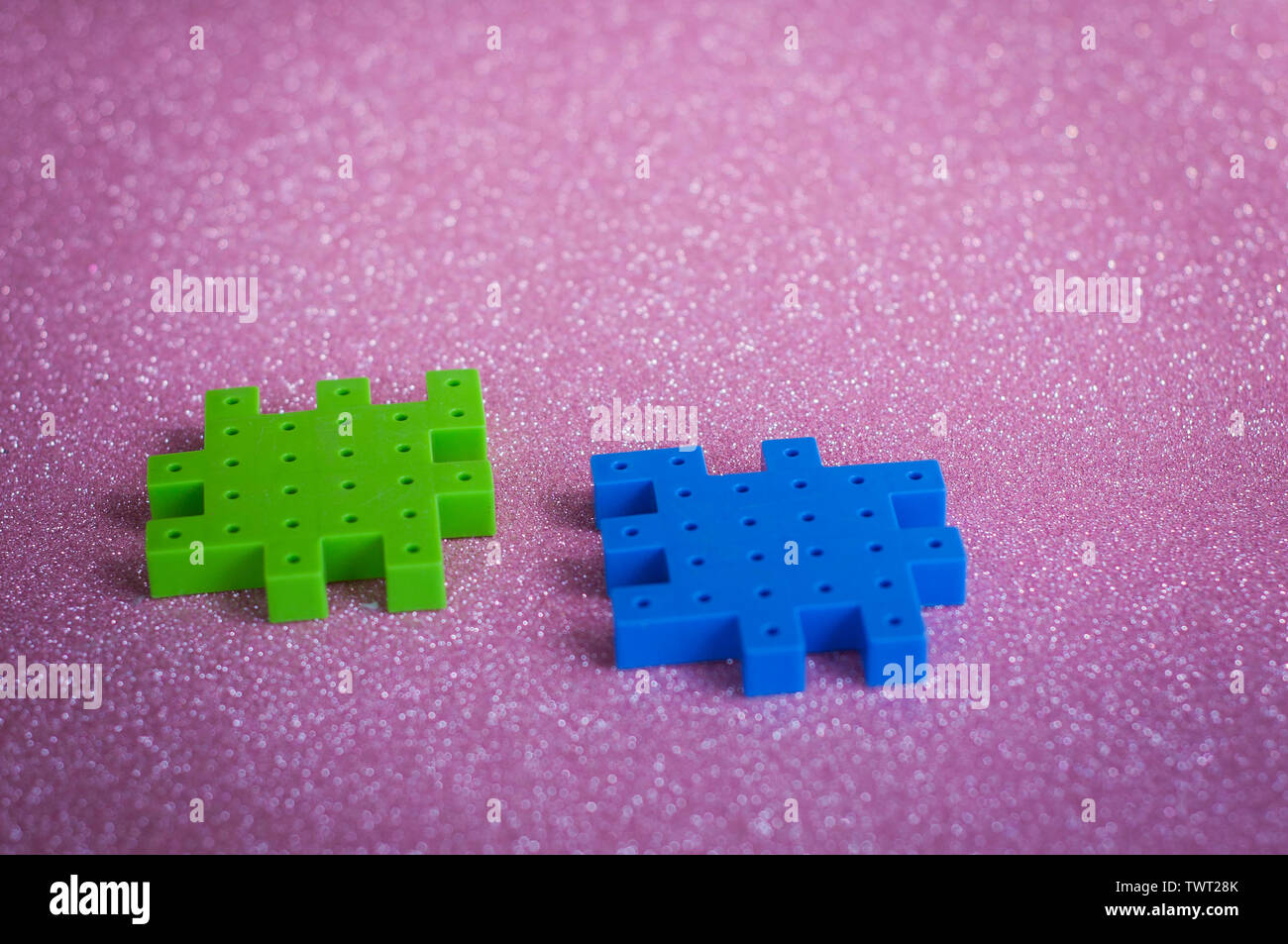 Colorful plastic puzzle pieces on pink Background Stock Photo - Alamy