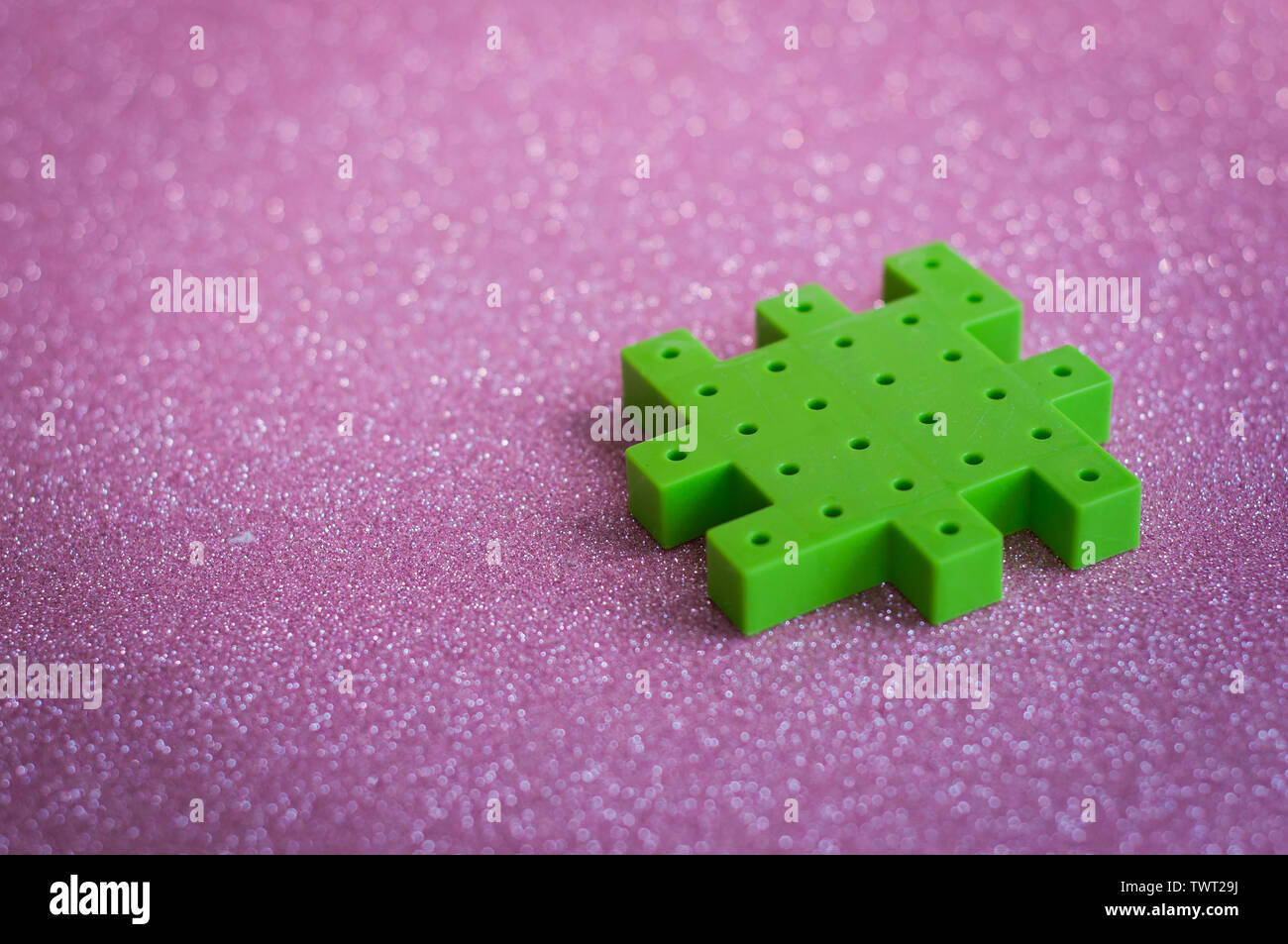 Colorful plastic puzzle pieces on pink Background Stock Photo - Alamy