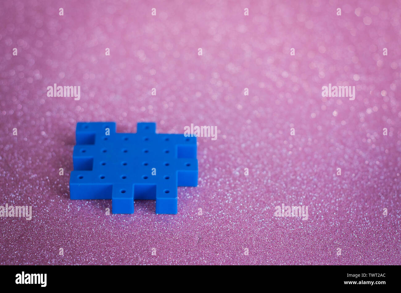 Colorful plastic puzzle pieces on pink Background Stock Photo - Alamy