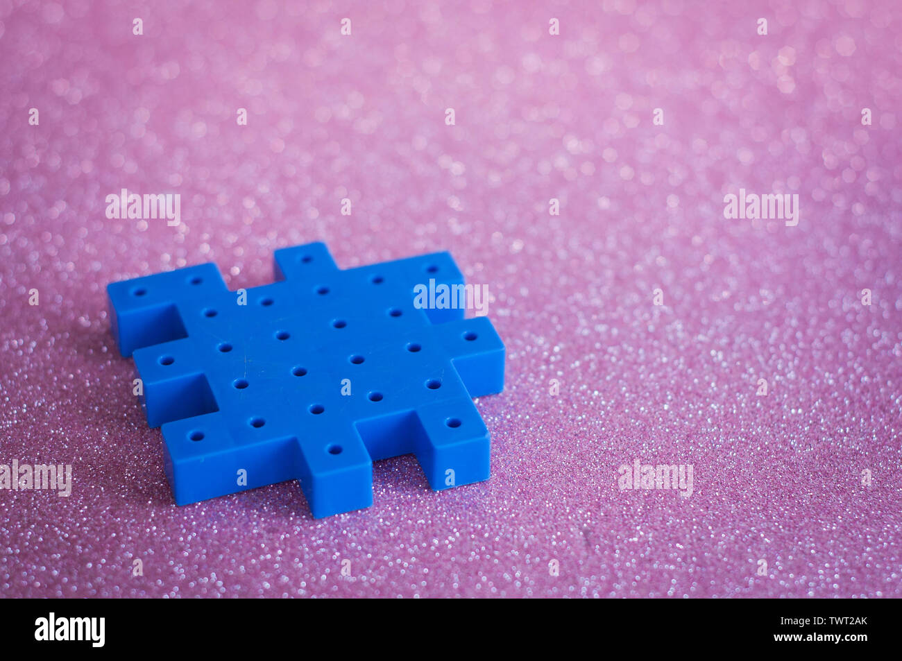 Colorful plastic puzzle pieces on pink Background Stock Photo - Alamy