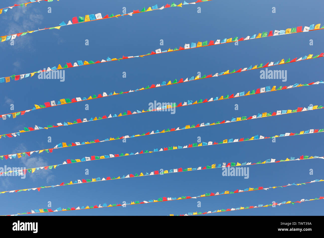 Blue sky with several lines of prayer flags in Lhasa. Traditionally ...