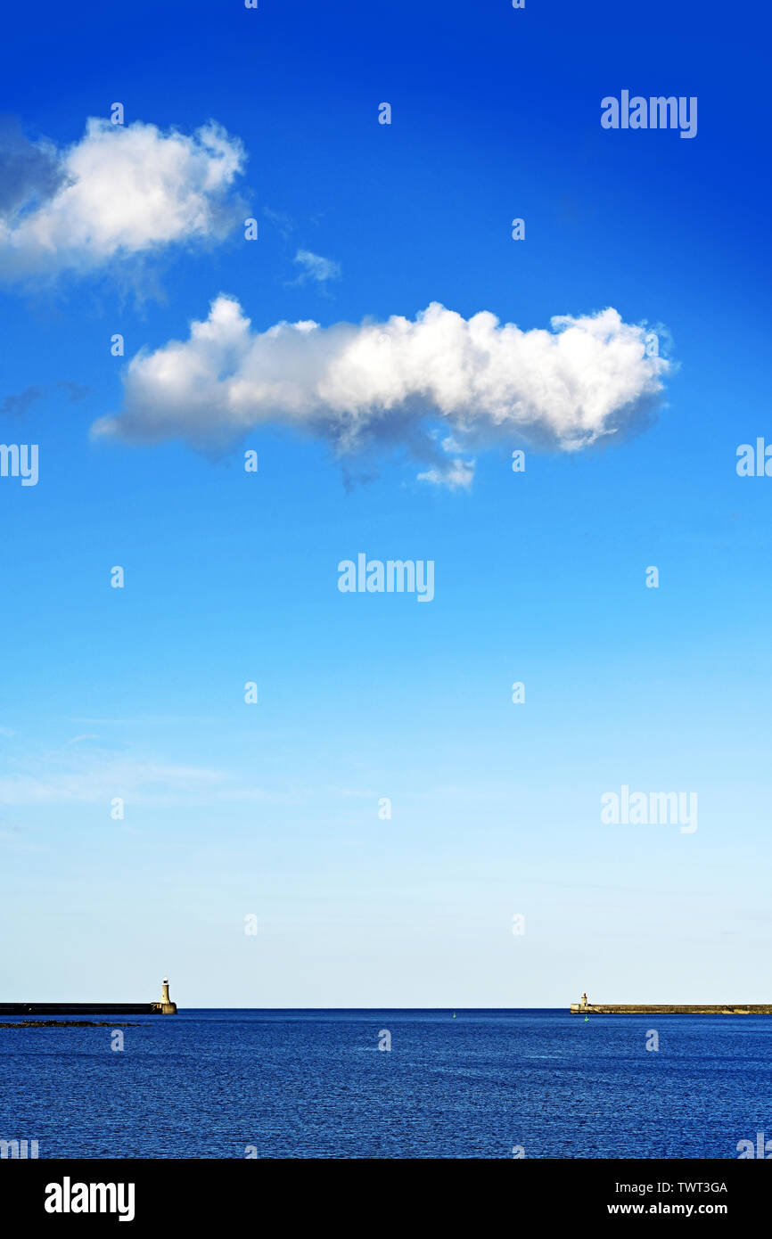 North and South piers at entrance to the river Tyne with fluffy white ...
