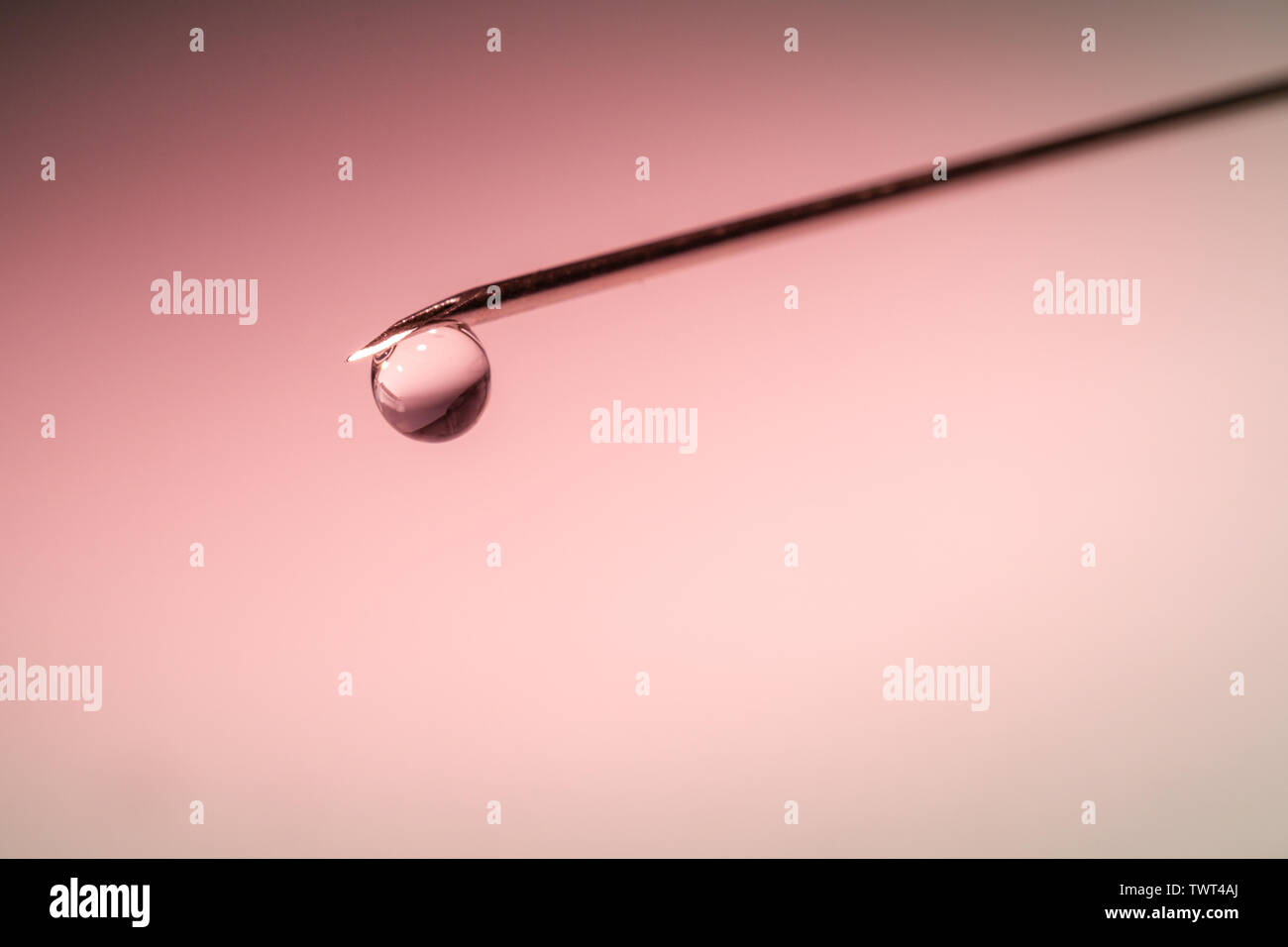 drop on the tip of needle - red background Stock Photo - Alamy