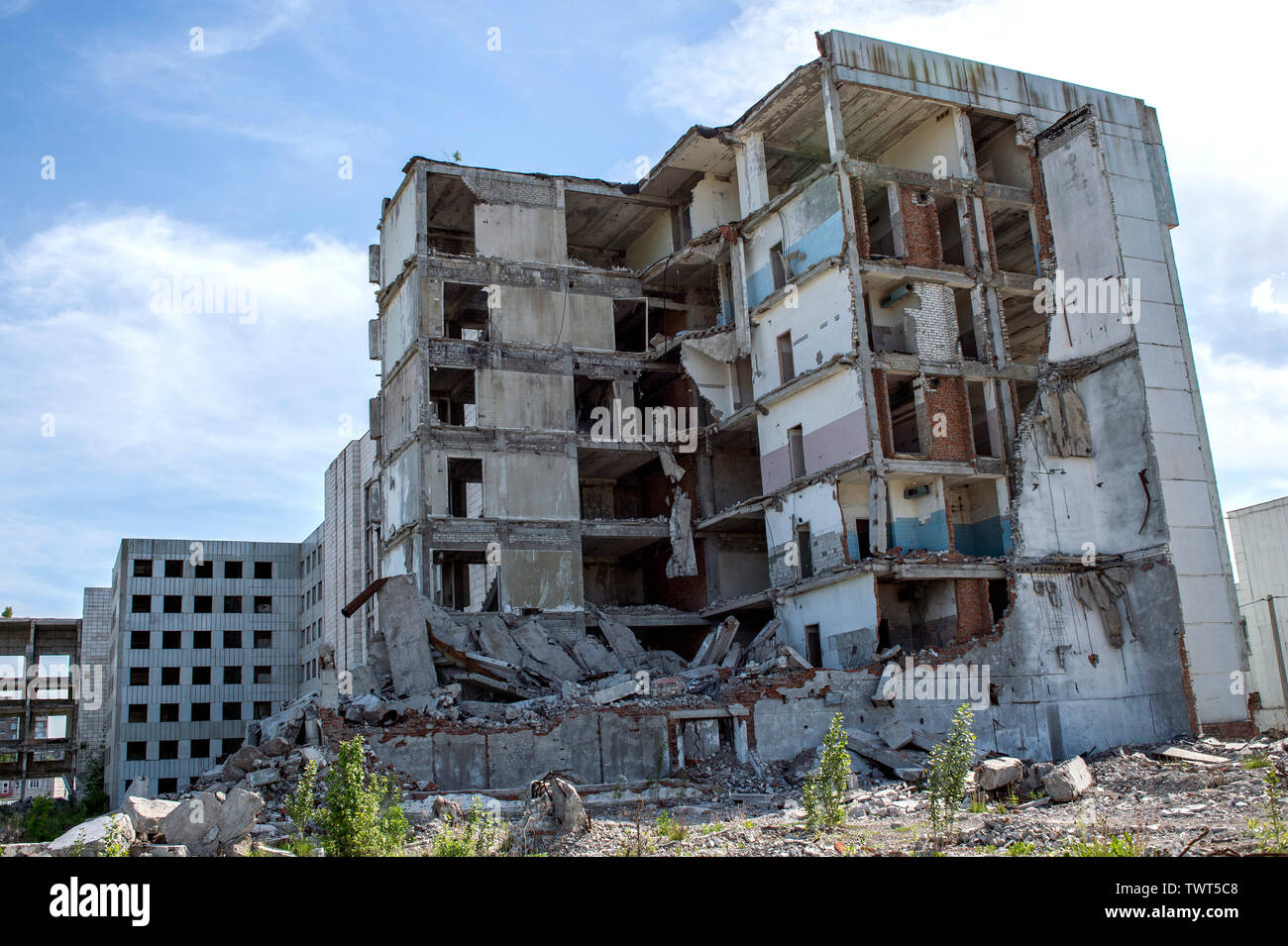 The remains of the destroyed concrete building against the textured ...