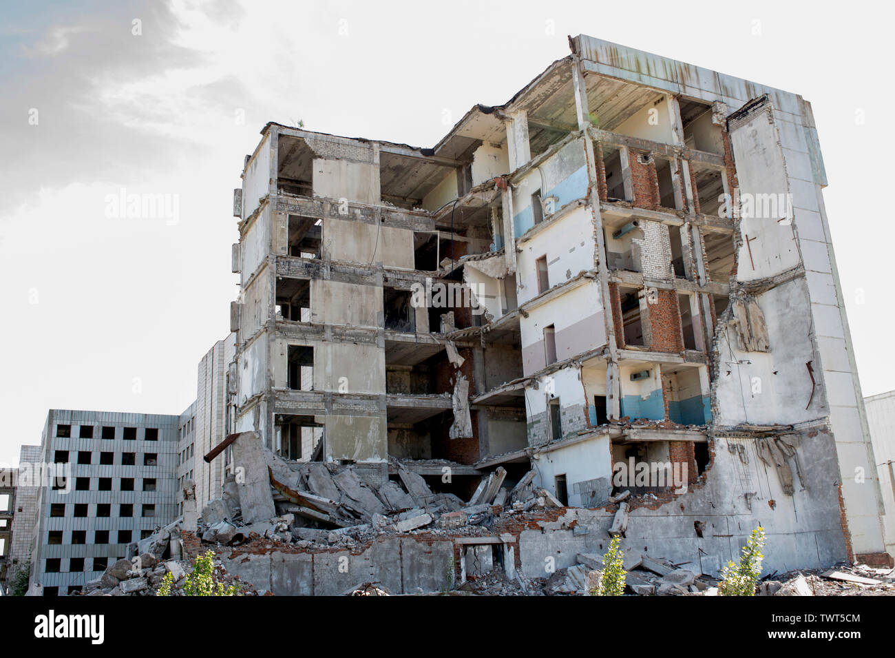 The remains of a destroyed concrete building against the sky ...