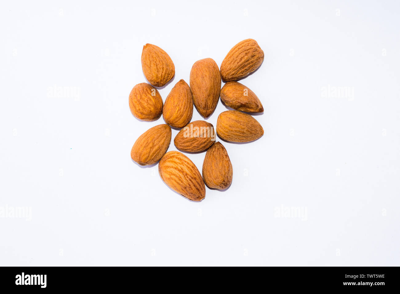 close up of brown almonds seeds isolated on white background,clipping ...