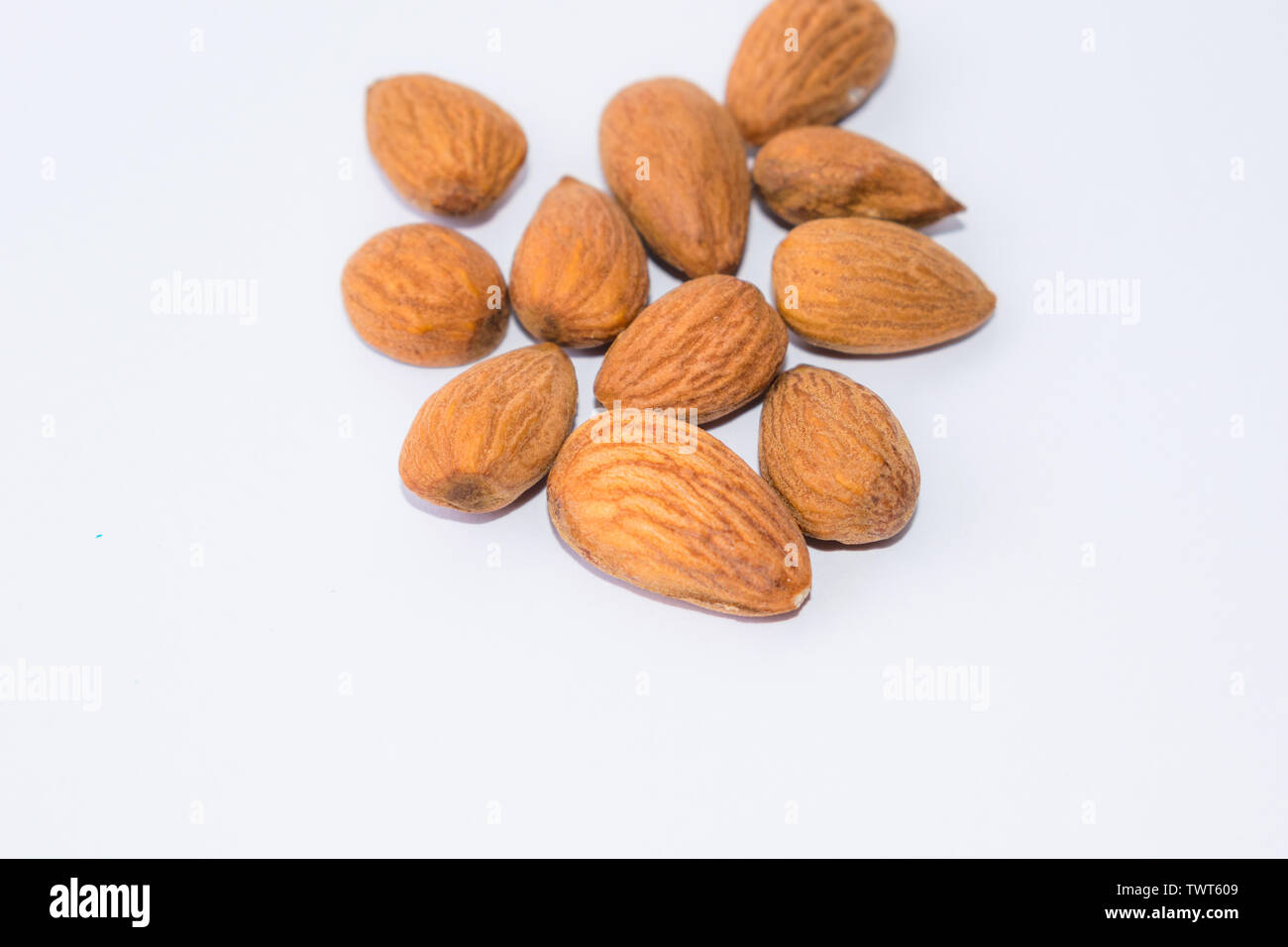 close up of brown almonds seeds isolated on white background,clipping ...