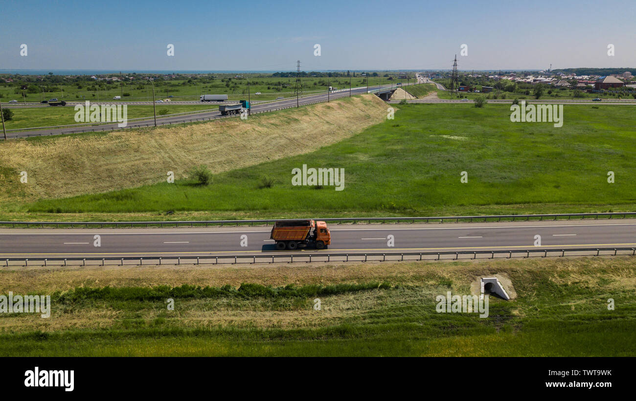 Aerial view of modern highway road intersection on rural landscape ...