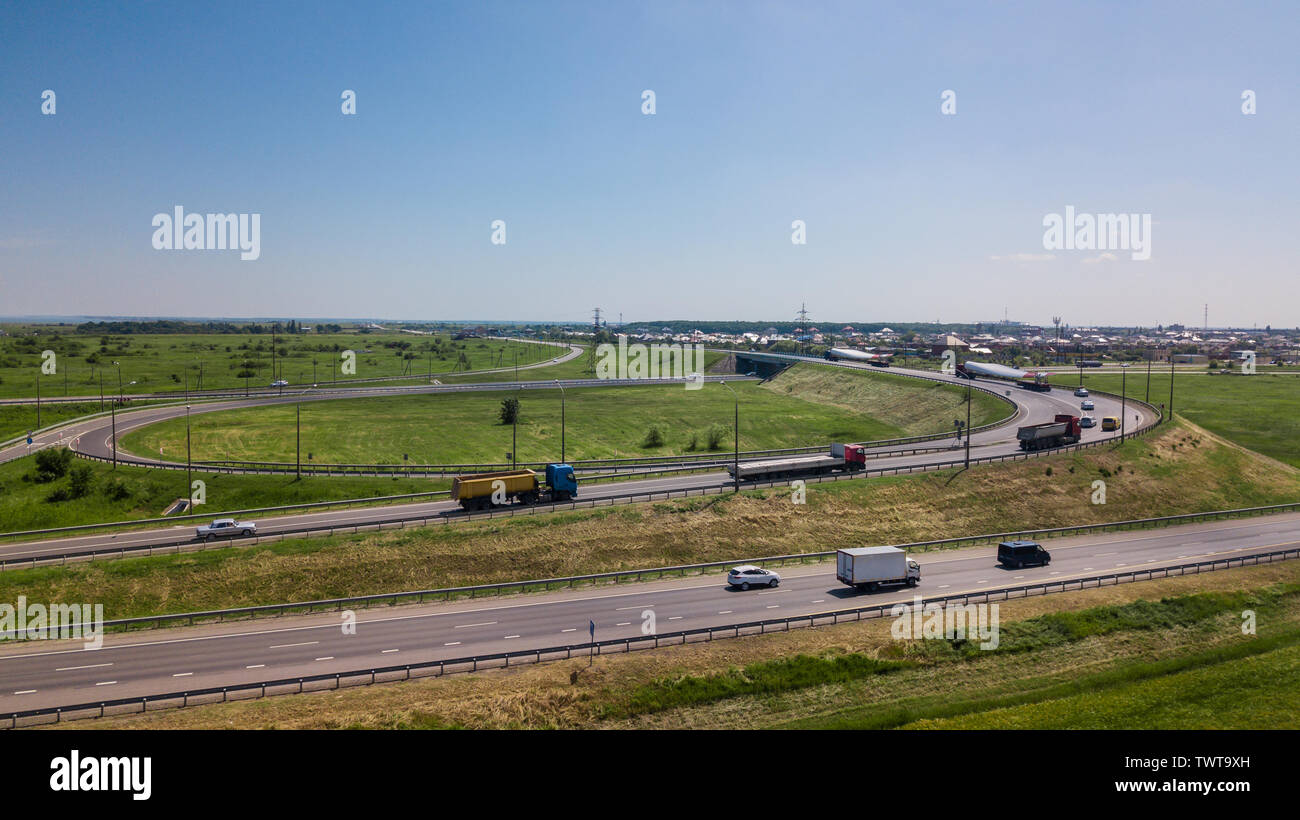 Aerial view of modern highway road intersection on rural landscape ...