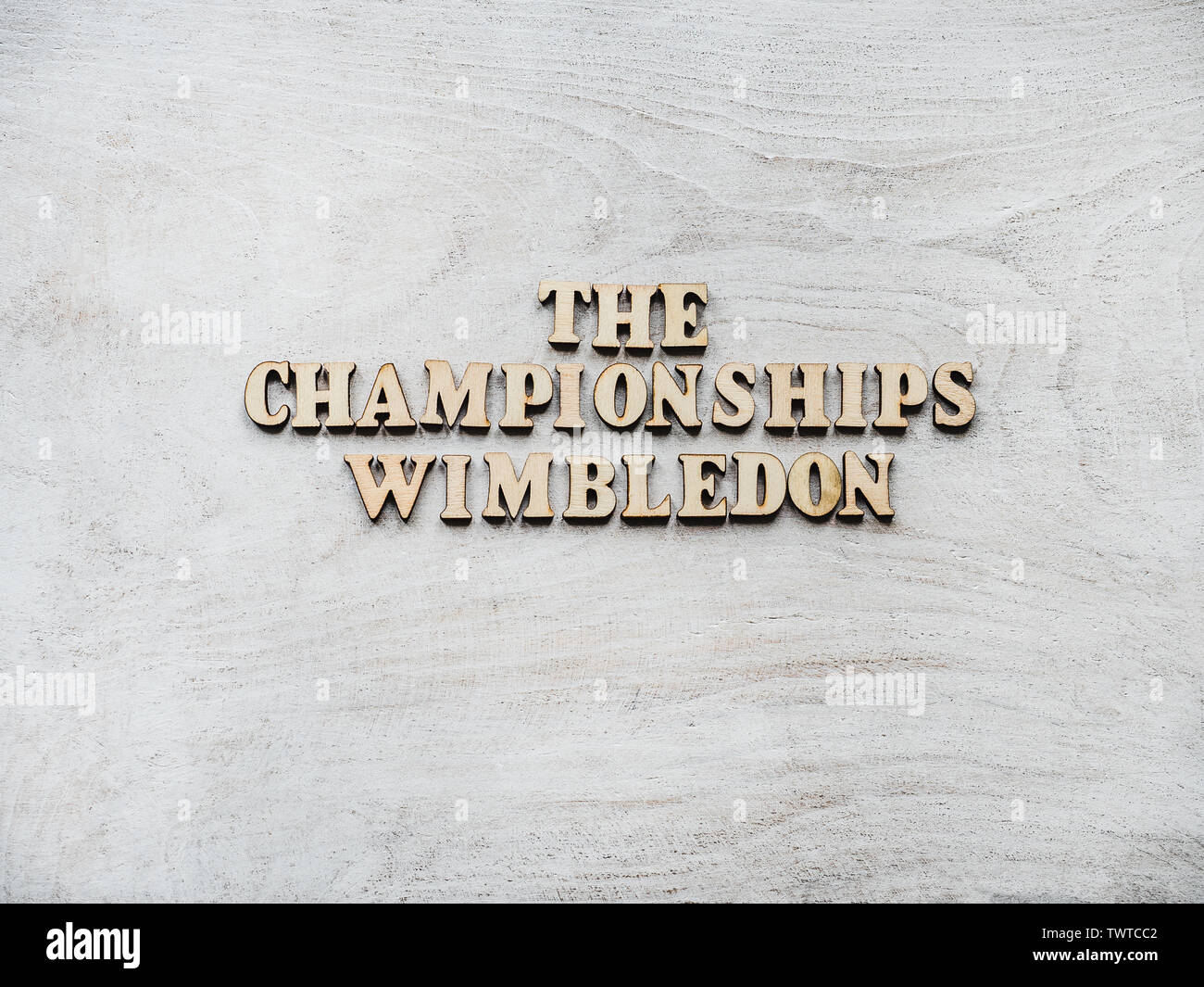 WIMBLEDON. Wooden, unpainted letters on a white table. Close-up, top ...
