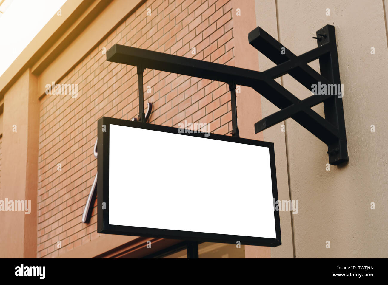 Empty signage and blank mock up hanging on street with copy space Stock ...