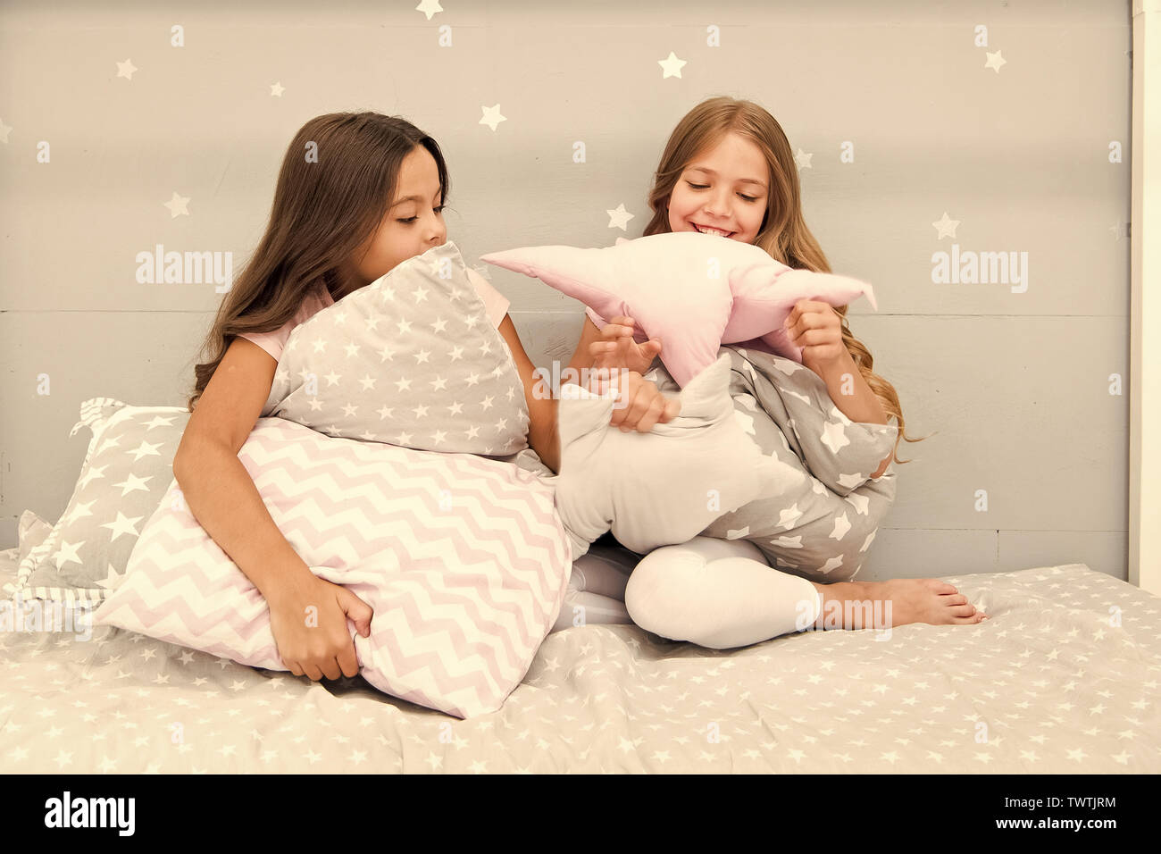 Girls happy friends with cute pillows. Pillow fight pajama party ...